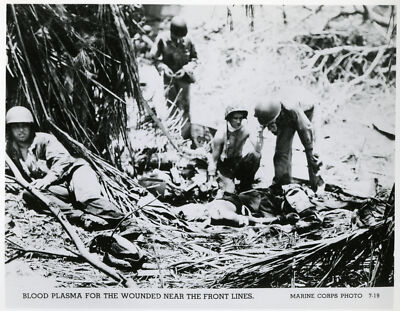 Injured US Marine receiving first aid near the front lines Guam 1944 ...