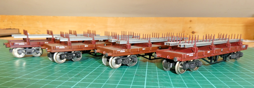 4 Lima Bogie bolster wagons each with a load of six railway rails ...