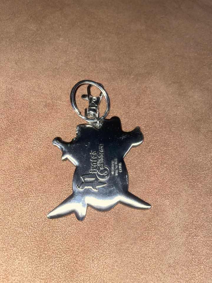 Disney's Pirates of the Caribbean Skull And Swords Pewter Keychain ...