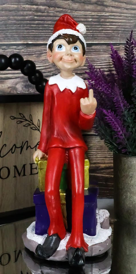 Naughty Christmas Elf Flipping The Bird Sitting On Santa Presents Shelf ...