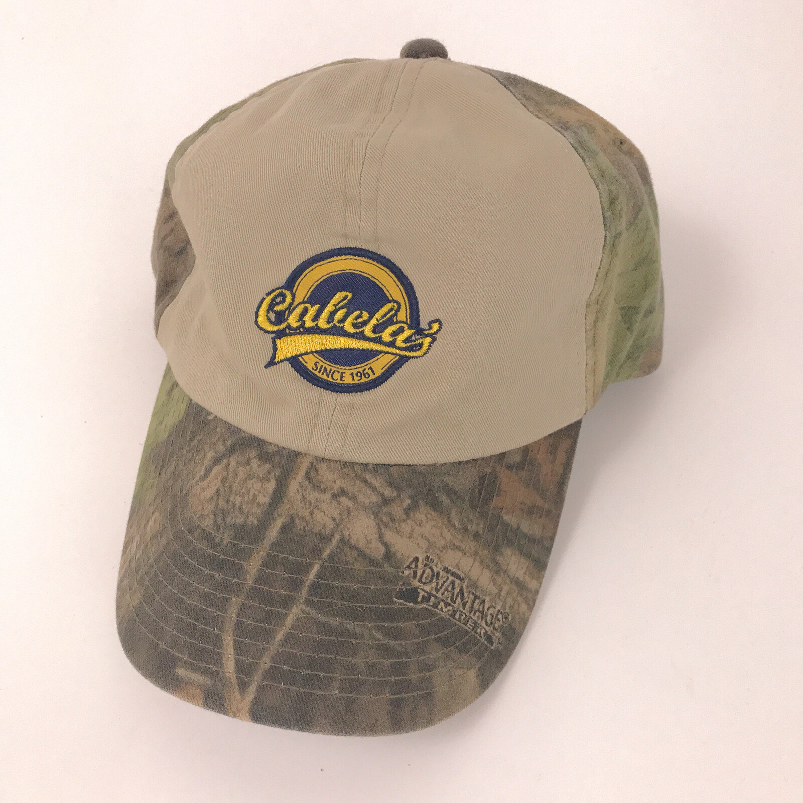 Cabala's round logo yellow blue on advantage camo hat… - Gem