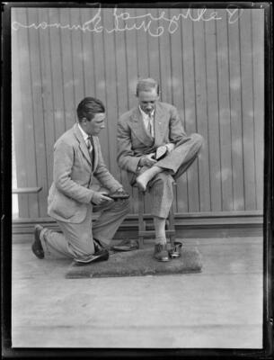 German athlete Dr Otto Peltzer trying on shoes at Mick Simmons, NS- Old ...
