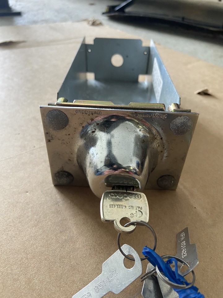 4 Greenwald coin boxes, washers or dryers, 1 Medeco Key. Dimensions 8*3 ...