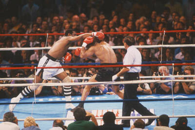 Mike Tyson blocks a punch from Michael Spinks in a boxing - Boxing 1988 ...