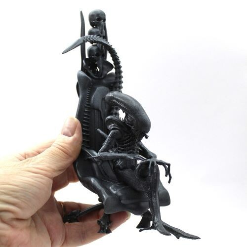 Alien Warrior in an HR Giger Harkonnen Capo Chair Stroking a Facehugger ...
