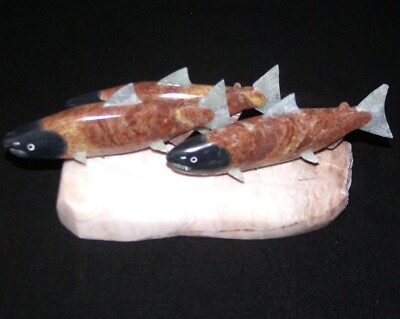 Three salmon stone sculpture on a white stone base | eBay