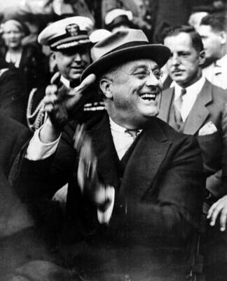 American President Franklin D Roosevelt smiles demonstrates to mem ...