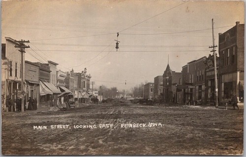 REINBECK, Iowa Real Photo RPPC Postcard "MAIN STREET, Looking East ...