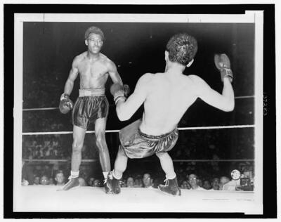 Sugar Ray Robinson in the ring with Jimmy Doyle,Boxers,Doyle is falling ...