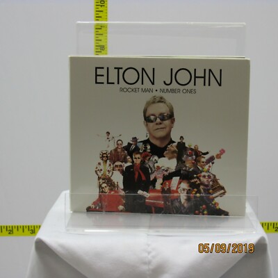 The listing is for the CD Rocket Man Number Ones by Elton John. | eBay