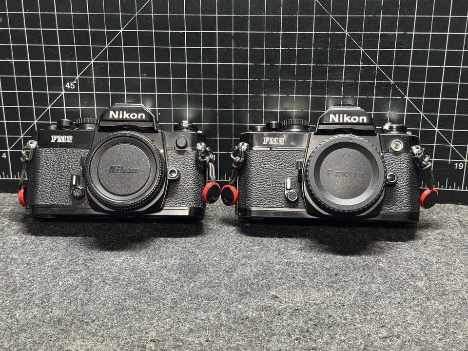 Black Nikon FM2n/FM2 kit with lenses, filters, straps, flash and ...