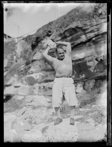 American wrestler Ed Strangler Lewis holding a rock over his h - 1930s ...