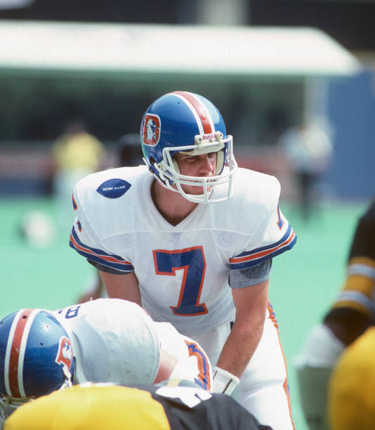 Quarterback John Elway of the Denver Broncos stands behind cente - 1983 ...