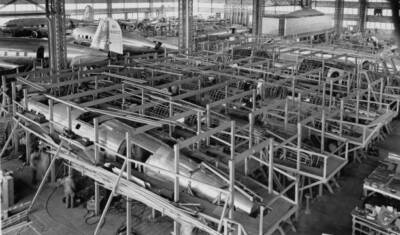 Aviation engineers around partially assembled aircraft fuselages, Old ...
