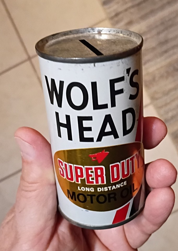 Three Vintage "WOLF'S HEAD OIL" AD ITEMS....CAN BANK + SERVICE STICKERS ...