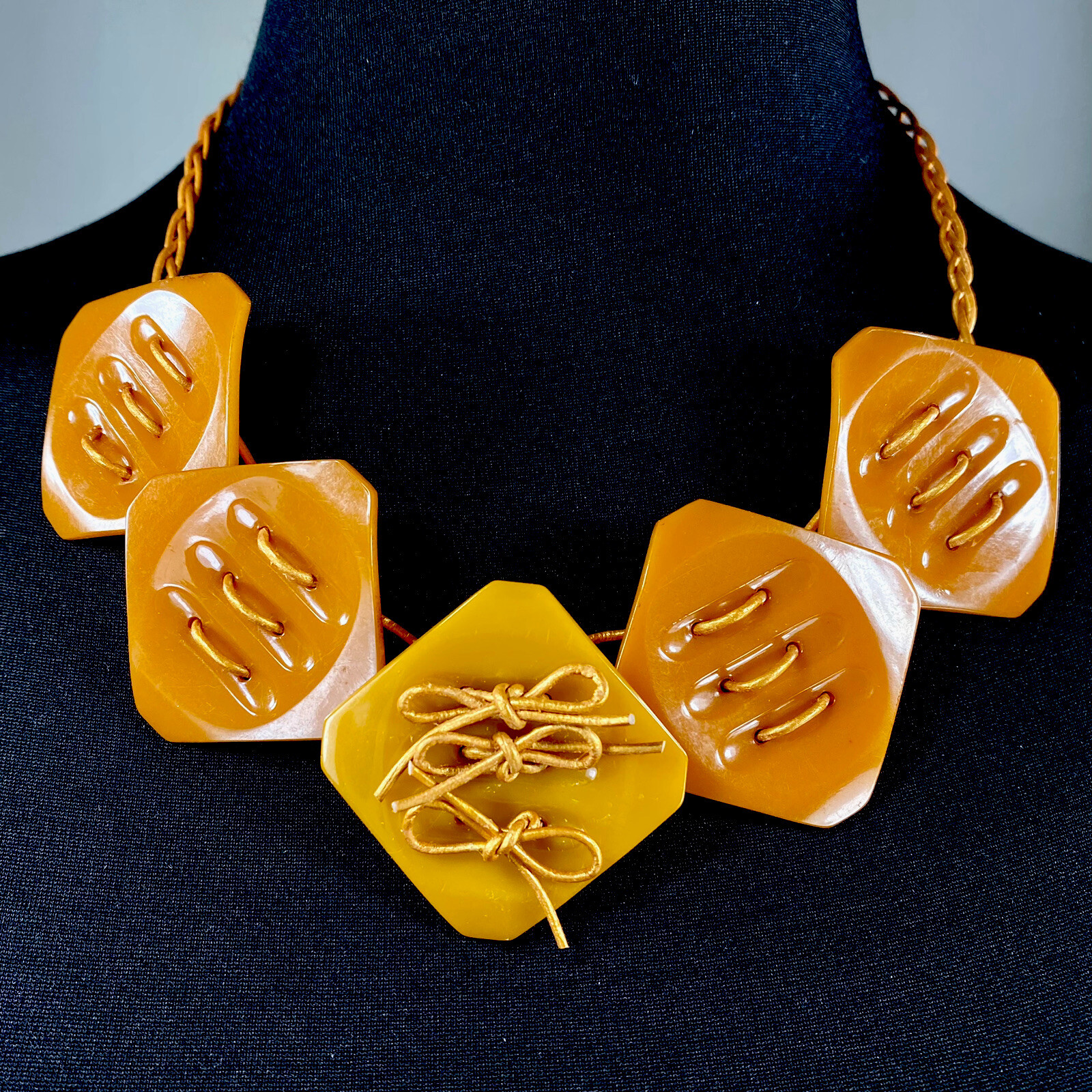 Buttons & Bows, Butterscotch Bakelite Necklace on Metallic Leather Cord ...