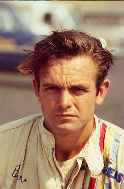 Driver Peter Revson stands around by the paddock 1968 Motor Racing Old ...