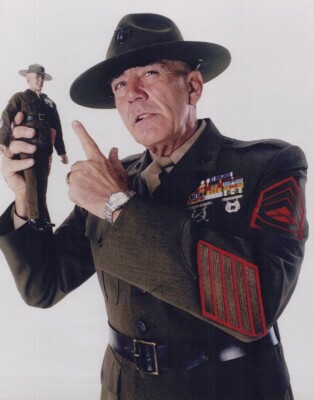 R. Lee Ermey holds up Full Metal Jacket action figure vintage 8x10 inch ...