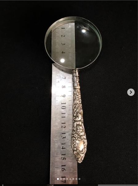Beautiful magnifying glass with a silver handle. The handle is made of ...