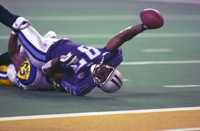 Titans wide receiver Kevin Dyson is tackled by Rams linebacker Mik- Old ...