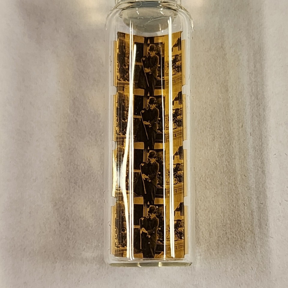 charlie chaplin vintage film cells . strip inside a vial, pouch and ...