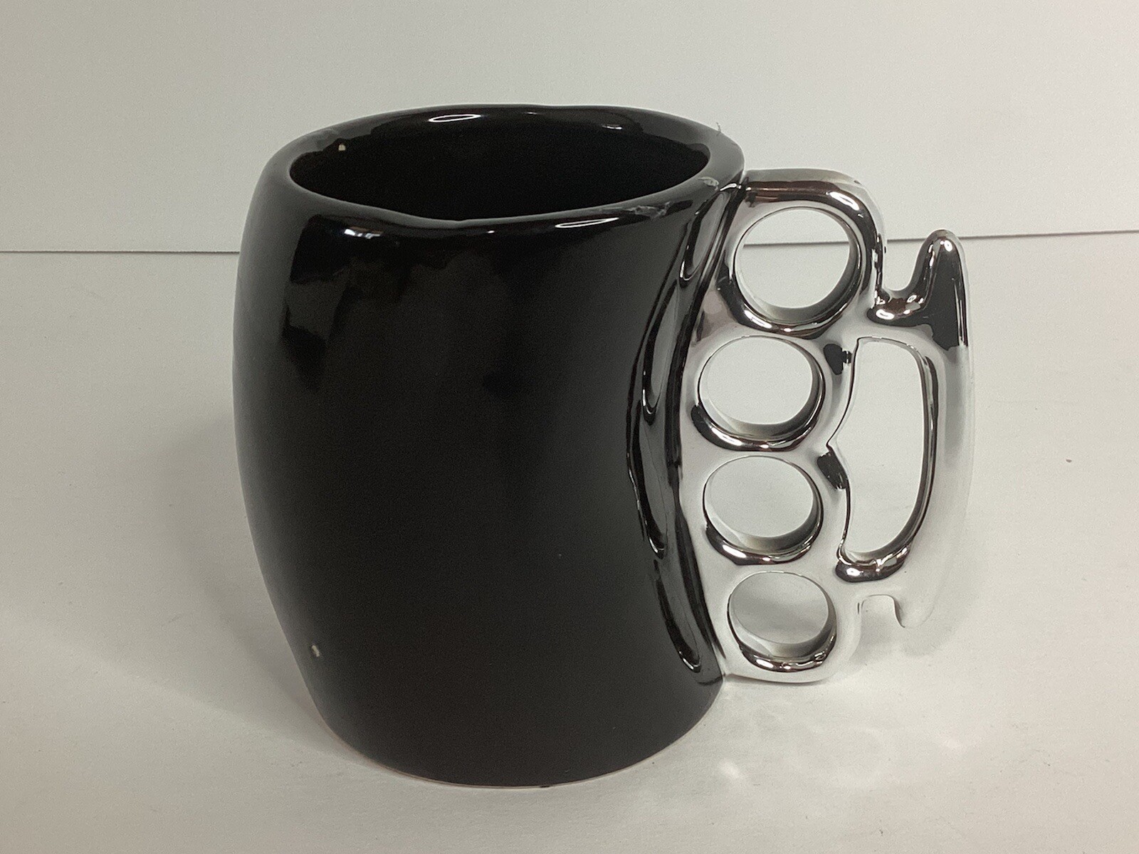Brass Knuckles Coffee Mug Dated 2002 Black Silver Tone FIST Fairly Odd ...