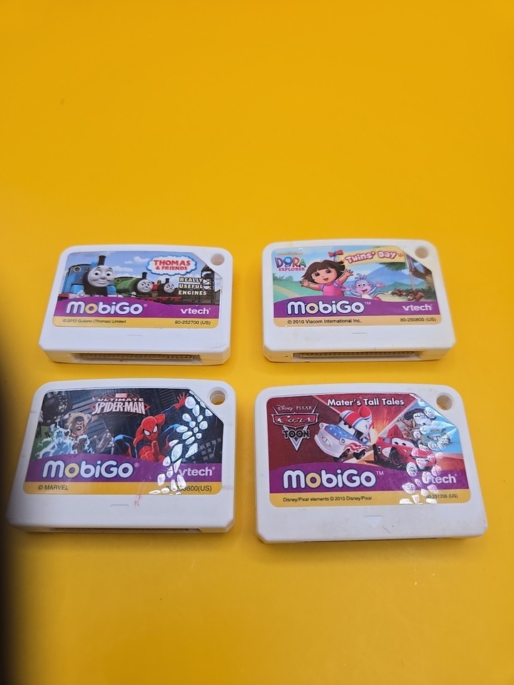 Vtech MobiGo Touch Learning System with 10 Games Dora Cars Mickey Exc ...