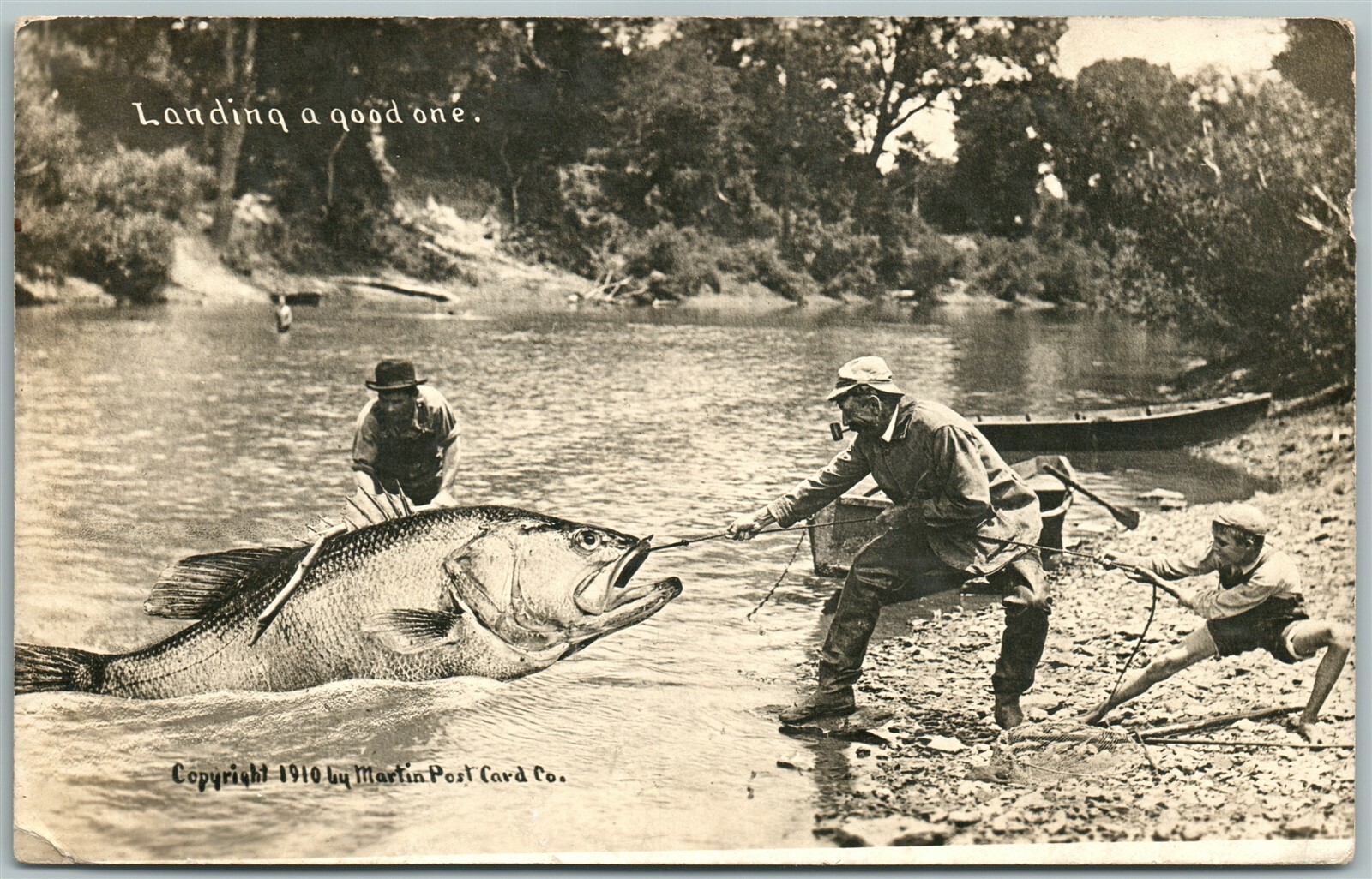 EXAGGERATED FISHING ANTIQUE REAL PHOTO POSTCARD RPPC LANDING A GOOD ONE ...