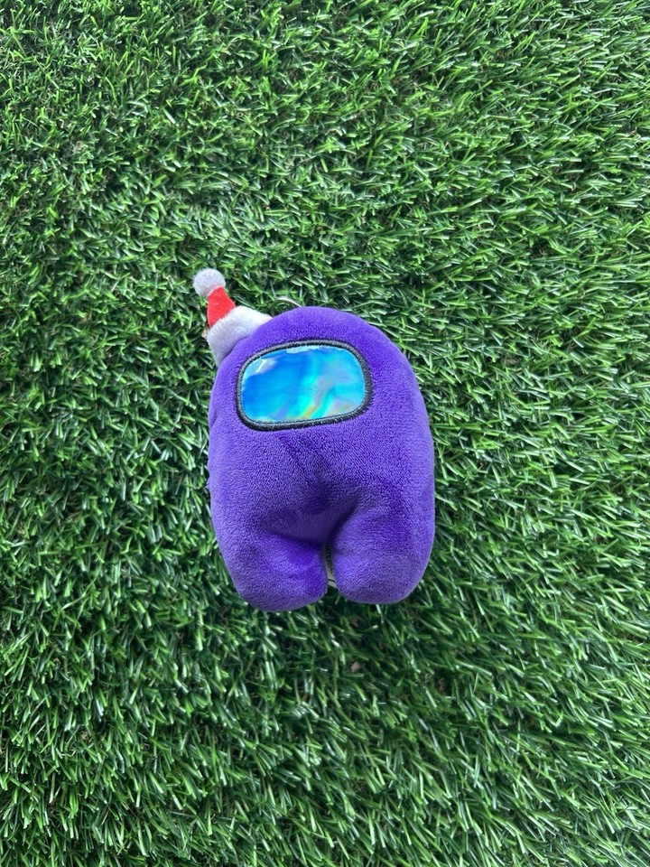 Among Us plush toy, specifically a purple crewmate wearing a Santa hat ...