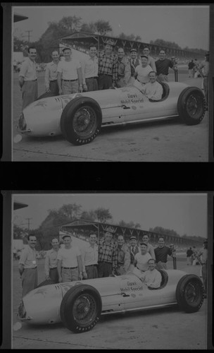 Duke Nalon sits in the #54 Novi Mobil Special as his crew stand 1949 ...
