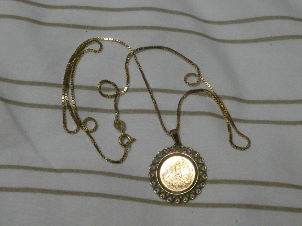 22 CRT. GOLD ANGEL COIN ON NINE CRT GOLD 18" INCH CHAIN. WEIGHT SHOWN ...