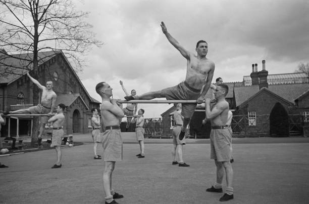 group young soldiers taking part an exercise routine six foot bamb ...