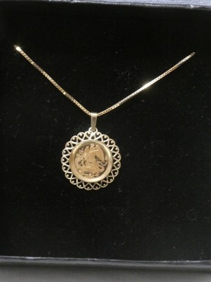 22 CRT. GOLD ANGEL COIN ON NINE CRT GOLD 18" INCH CHAIN. WEIGHT SHOWN ...