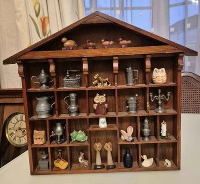A vintage shadow box with a collection of small, miniature decorative ...