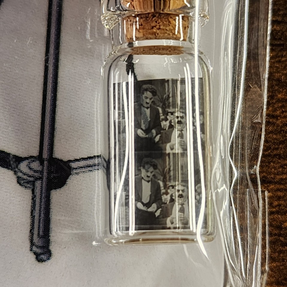 charlie chaplin vintage film cells . strip inside vial , photo montage ...