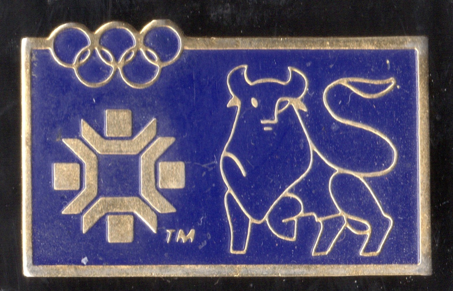 1984 SARAJEVO OLYMPIC GAMES. MERILL LYNCH PIN. BULL ON BLUE BACKGROUND ...