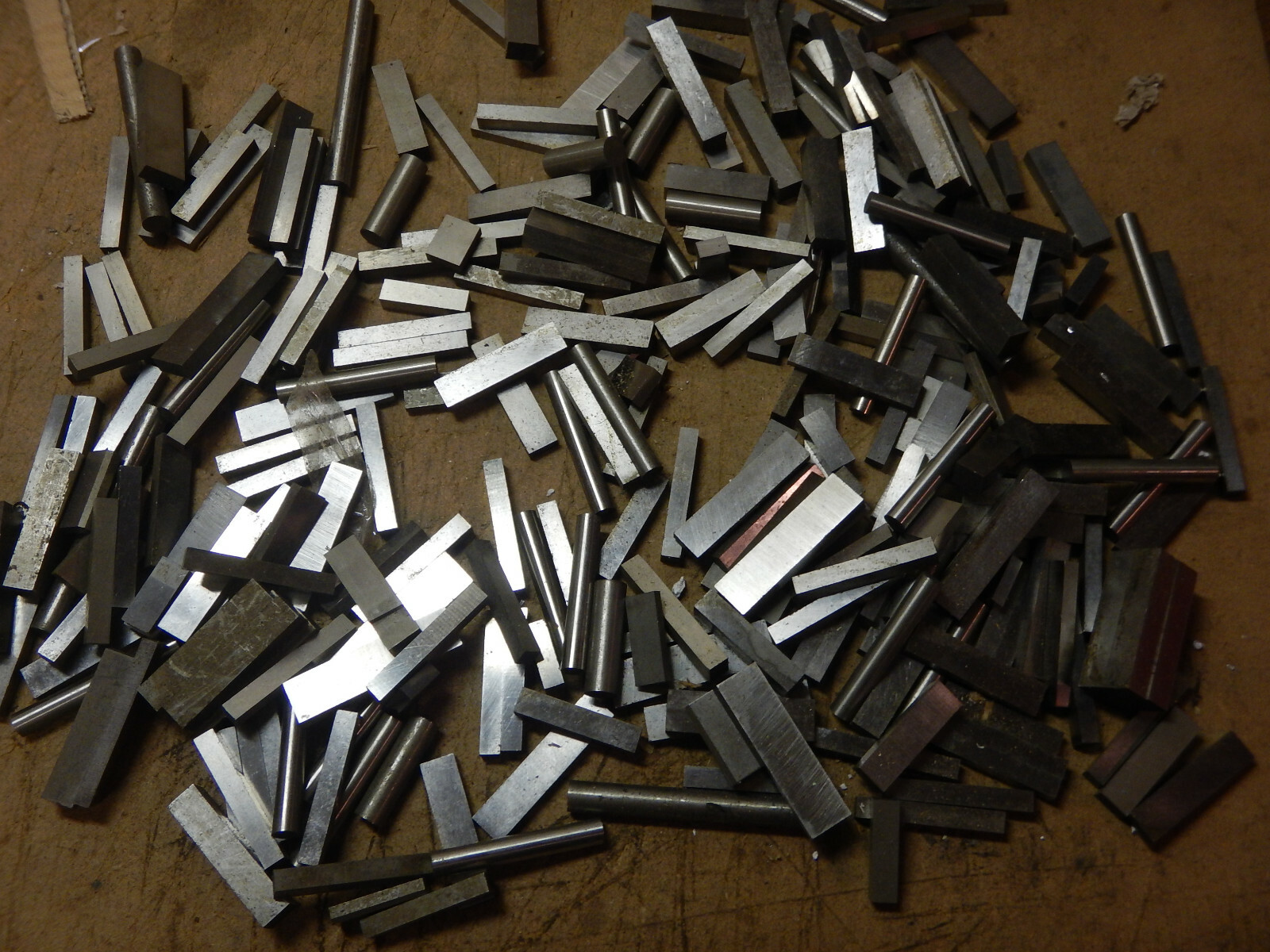PILE OF SMALL METAL PIECES FROM A GAGE GAUGE BLOCK PIN GAGE GRINDING ...