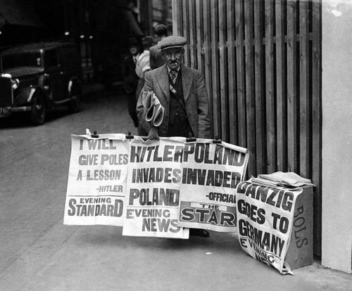 A Newspaper vendor a London street displays headlines announcing G ...