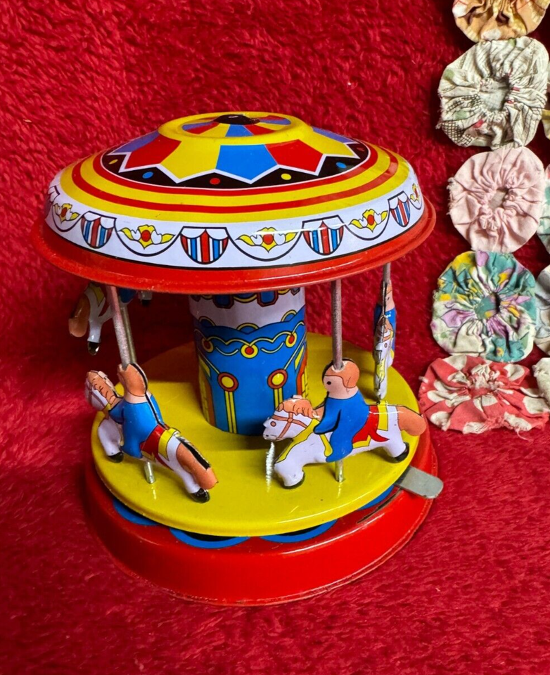 Old Fashioned Style Tin Toy Carousel with Little Riders on Ponies ...