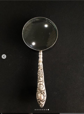 Beautiful magnifying glass with a silver handle. The handle is made of ...