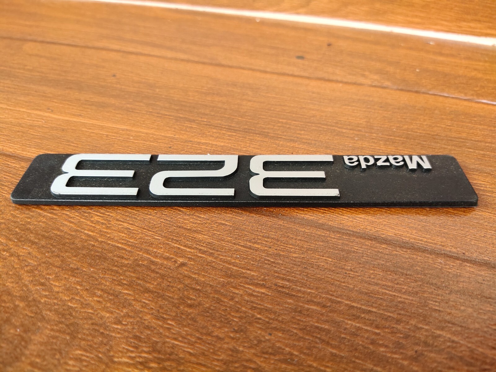 MAZDA 323 REAR EMBLEM BADGE LOGO ORNAMENT " MAZDA 323 " 1977-1980 NOS ...