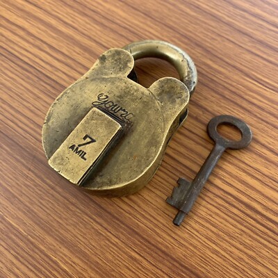 An old or antique Brass padlock or lock with key, decorative shape ...