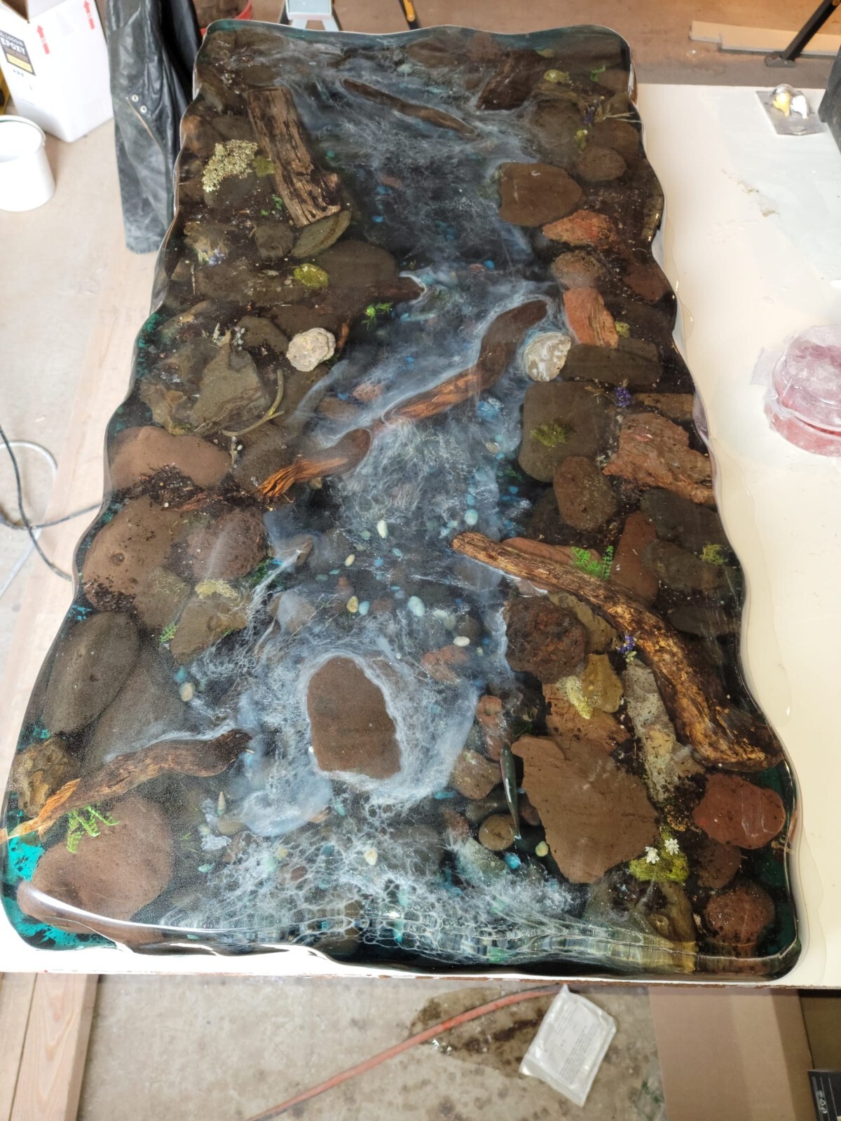epoxy river rock table with natural flowers, moss, rocks and nature in ...