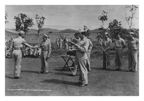 Lt General George C Kenney congratulates a member of 43rd Bomb Group ...