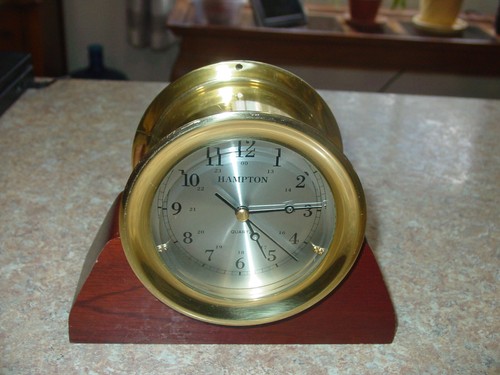 Hampton ship's clock in heavy brass case, beveled glass, wood base ...