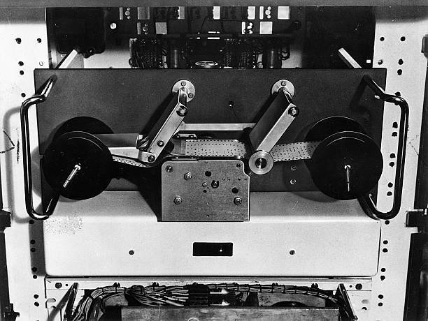 Punched tape passing through computer's reader order be decoded 19- Old ...