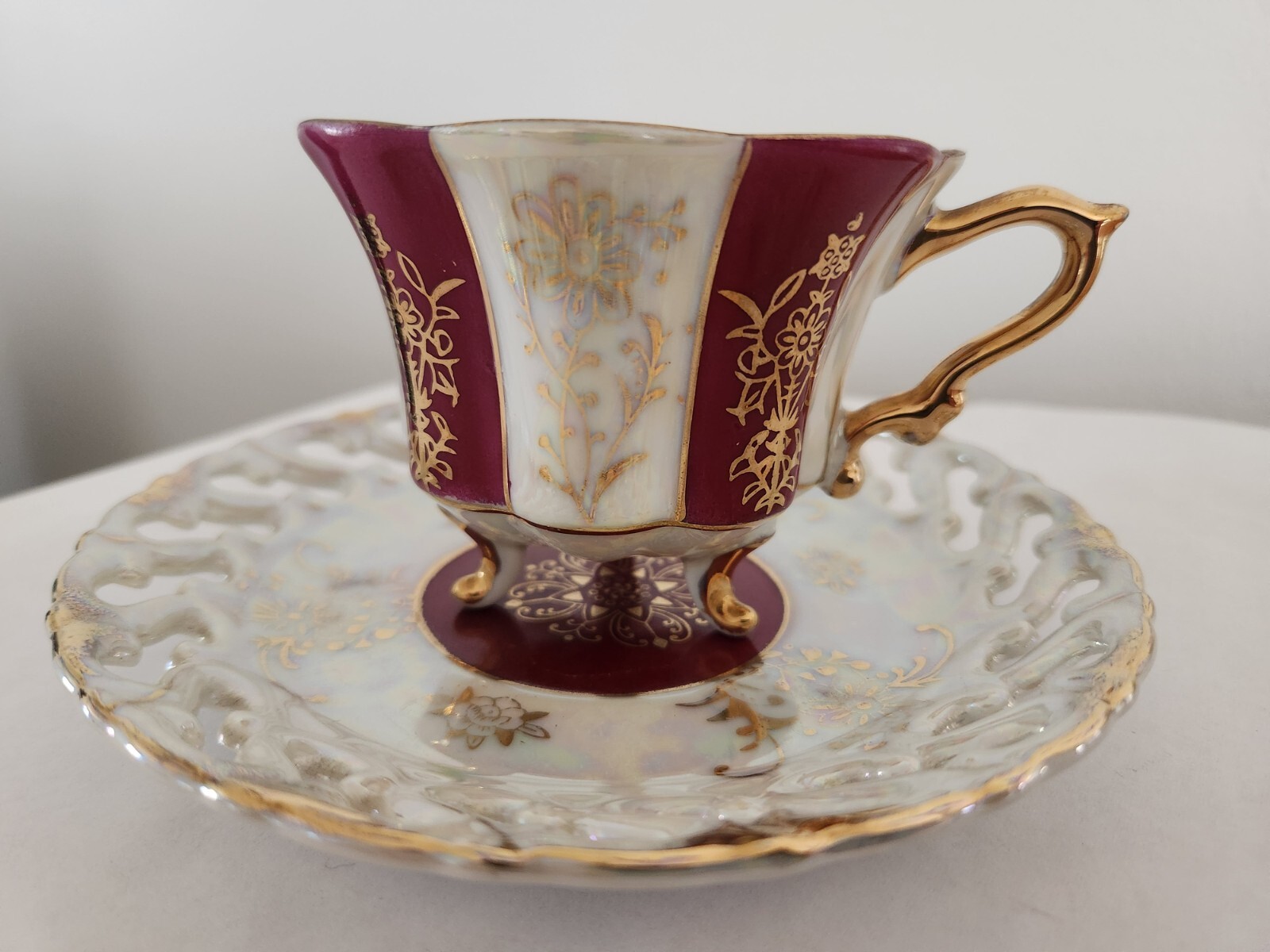 Collectible 3-footed tea Cup & Pierced Saucer burgundy and gold colors ...