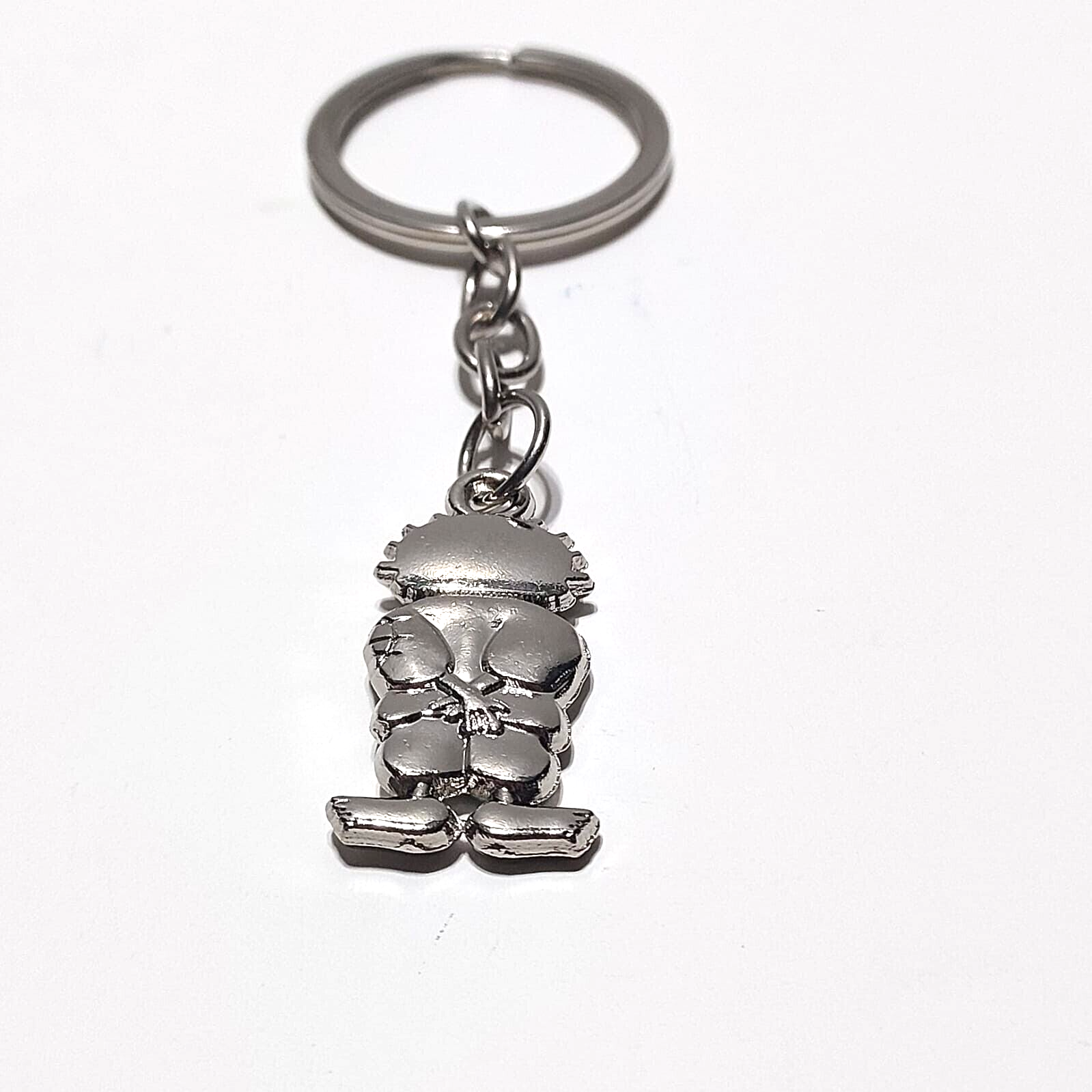 A metal key holder in the shape of the Palestinian character Hanzala ...