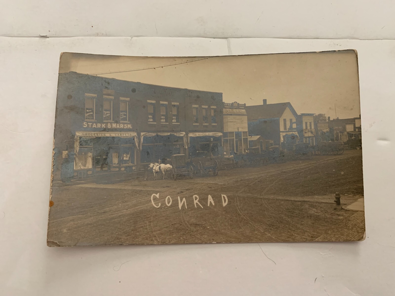 c.1910 Stark & Marsh Grocers & Carpets Main Street Conrad Iowa RPPC ...