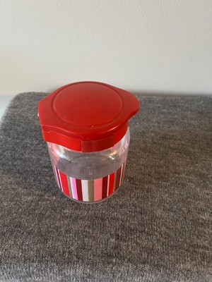Clear round plastic storage container with red striped body and red ...
